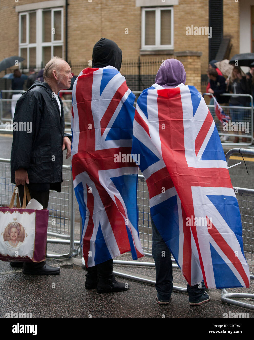 By-standers wearing Union Jack flags wait for a glimpse of the Royal ...