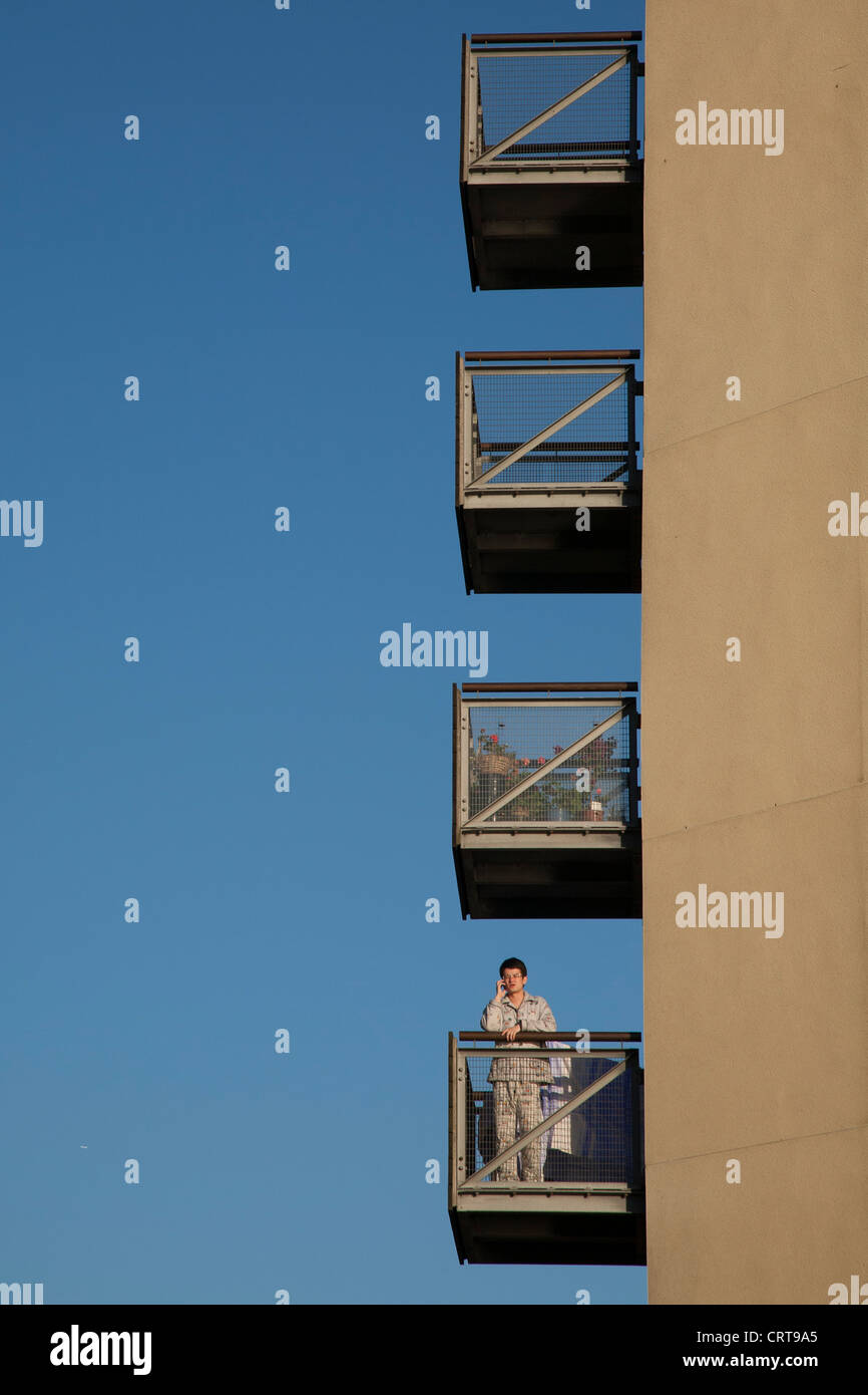 Man on balcony of high-rise Stock Photo - Alamy