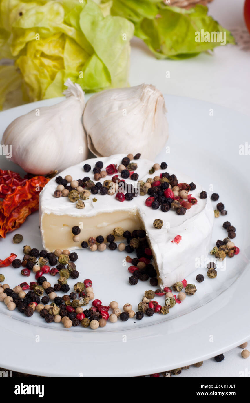 cheese camembert with color pepper spice Stock Photo - Alamy