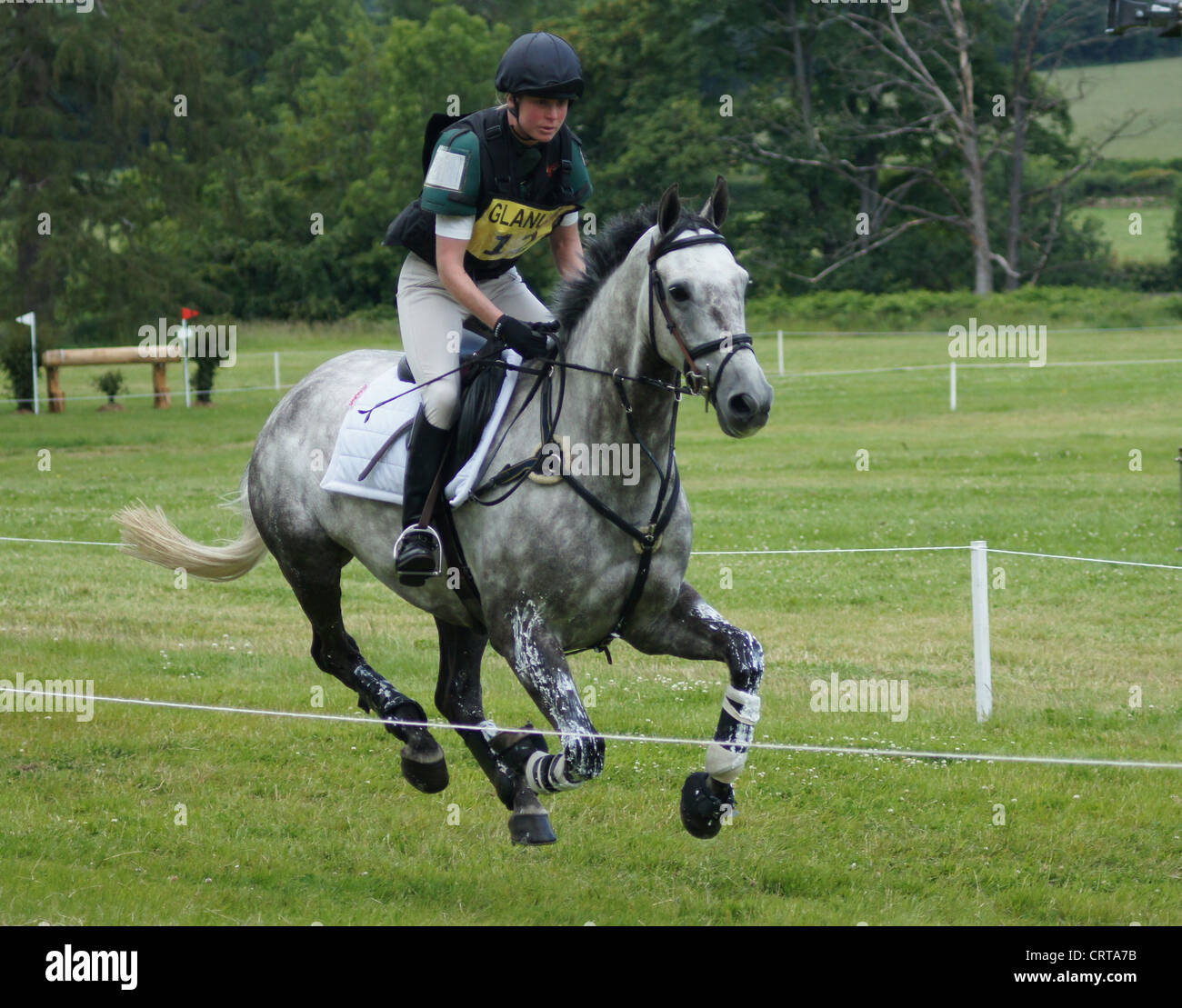 Female event rider and horse galloping from the start box on the CIC ...