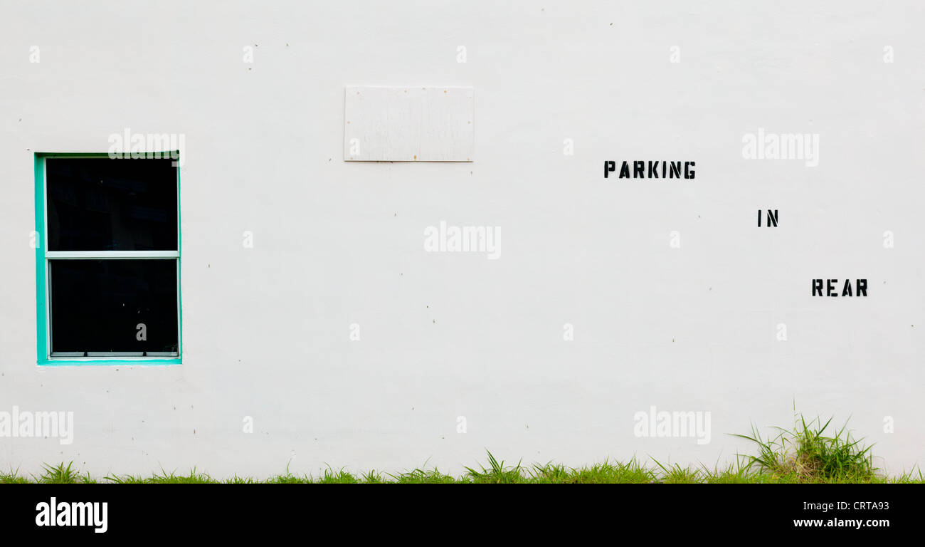 Wall with window and parking sign Stock Photo - Alamy