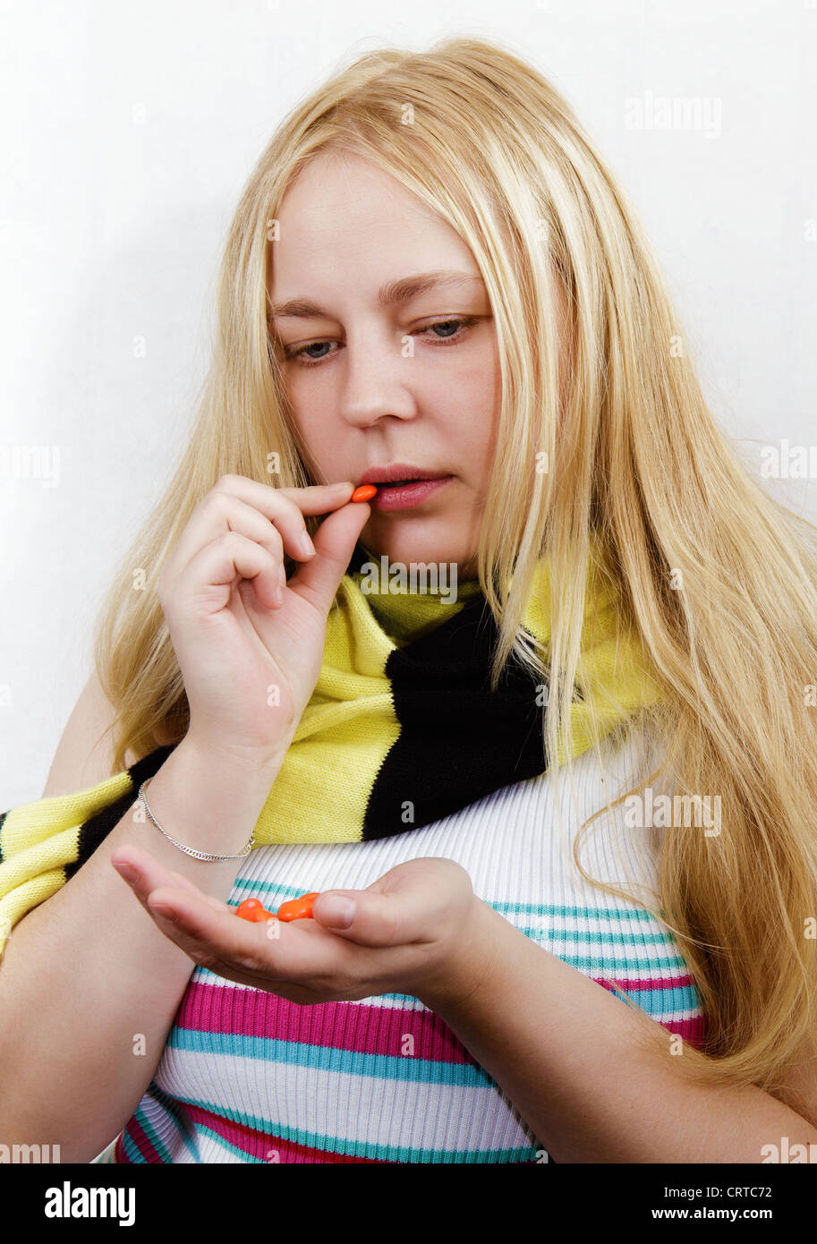 girl with pills, wrapped in a scarf. white background Stock Photo - Alamy