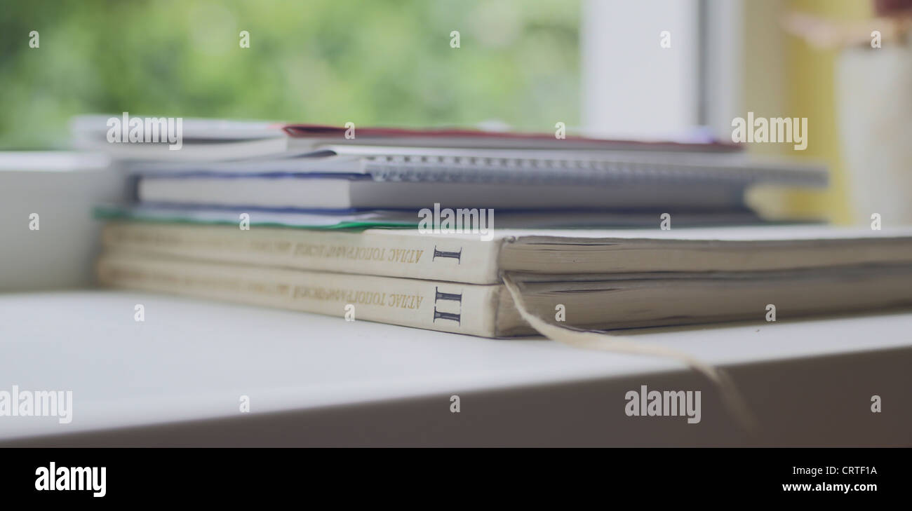 Few books and notebooks laying on window ledge Stock Photo - Alamy