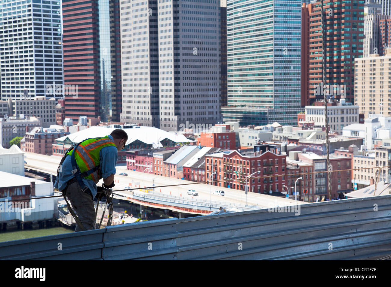 Workman working on Brooklyn Bridge dangerously close overhanging the ...