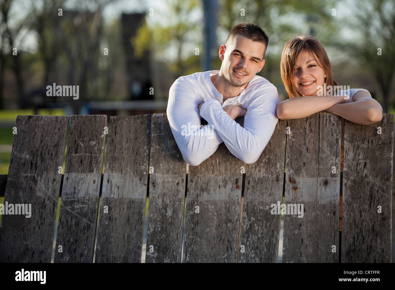 Couple by the fence Stock Photo - Alamy