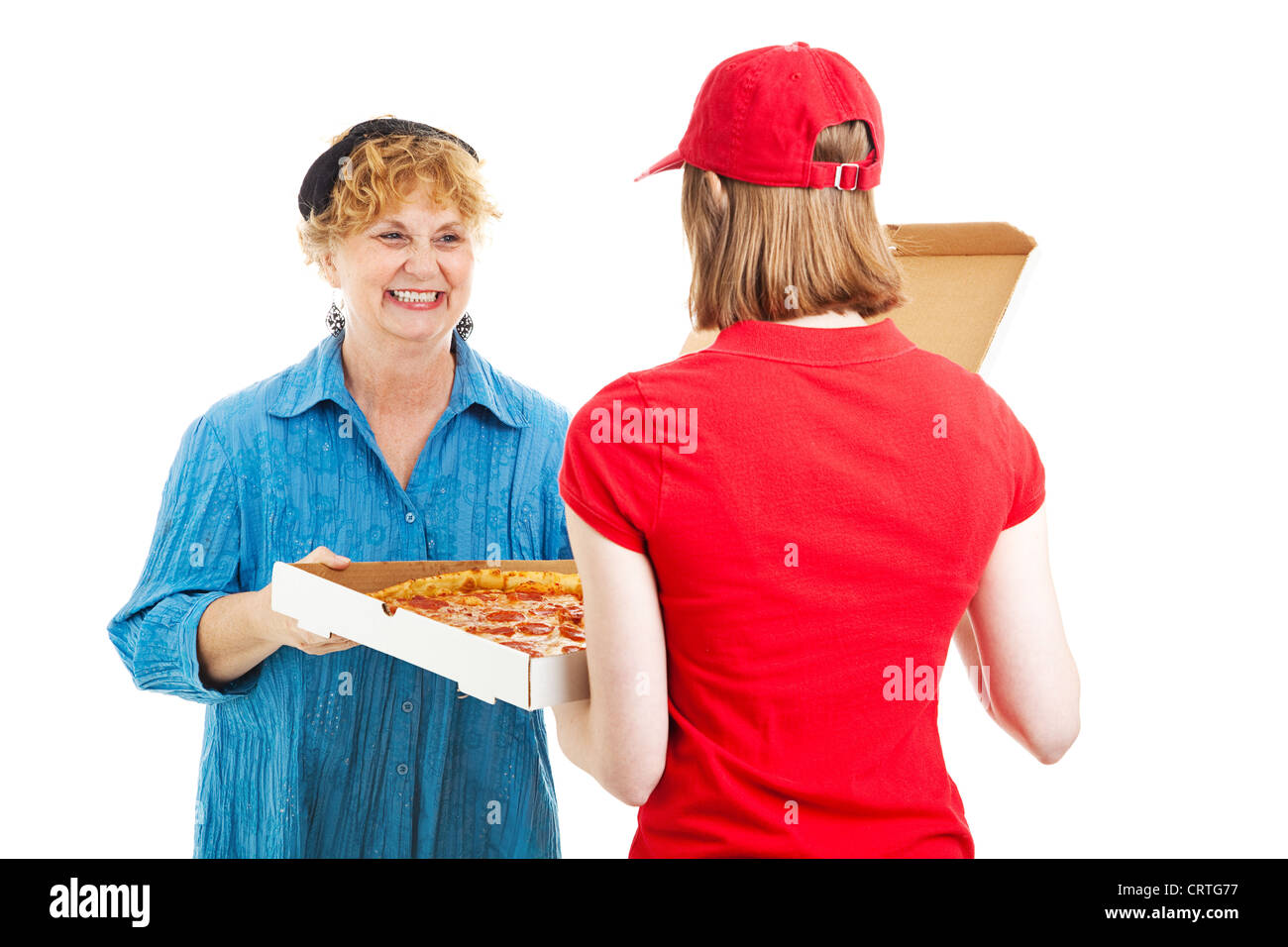 Mature woman accepting a pizza from a young delivery girl. Isolated on ...
