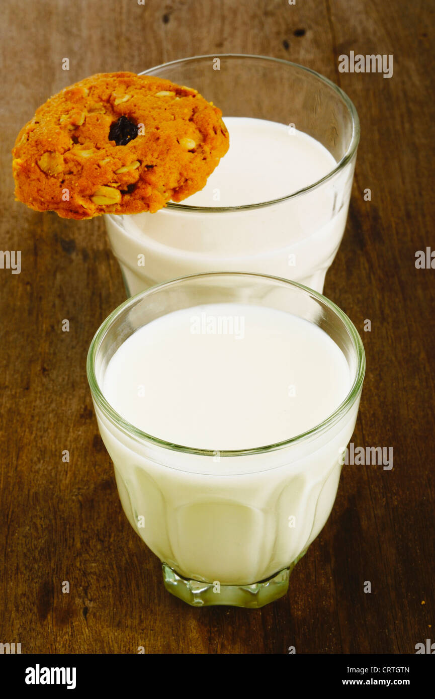 milk and cookie on wooden Stock Photo - Alamy