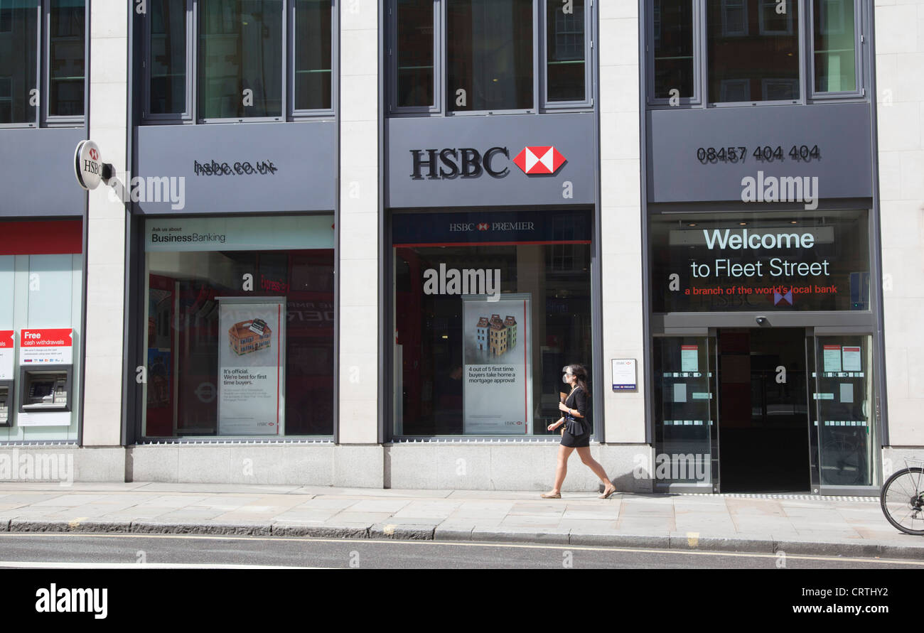 Woman walking past a branch of HSBC bank in Fleet Street, London Stock ...