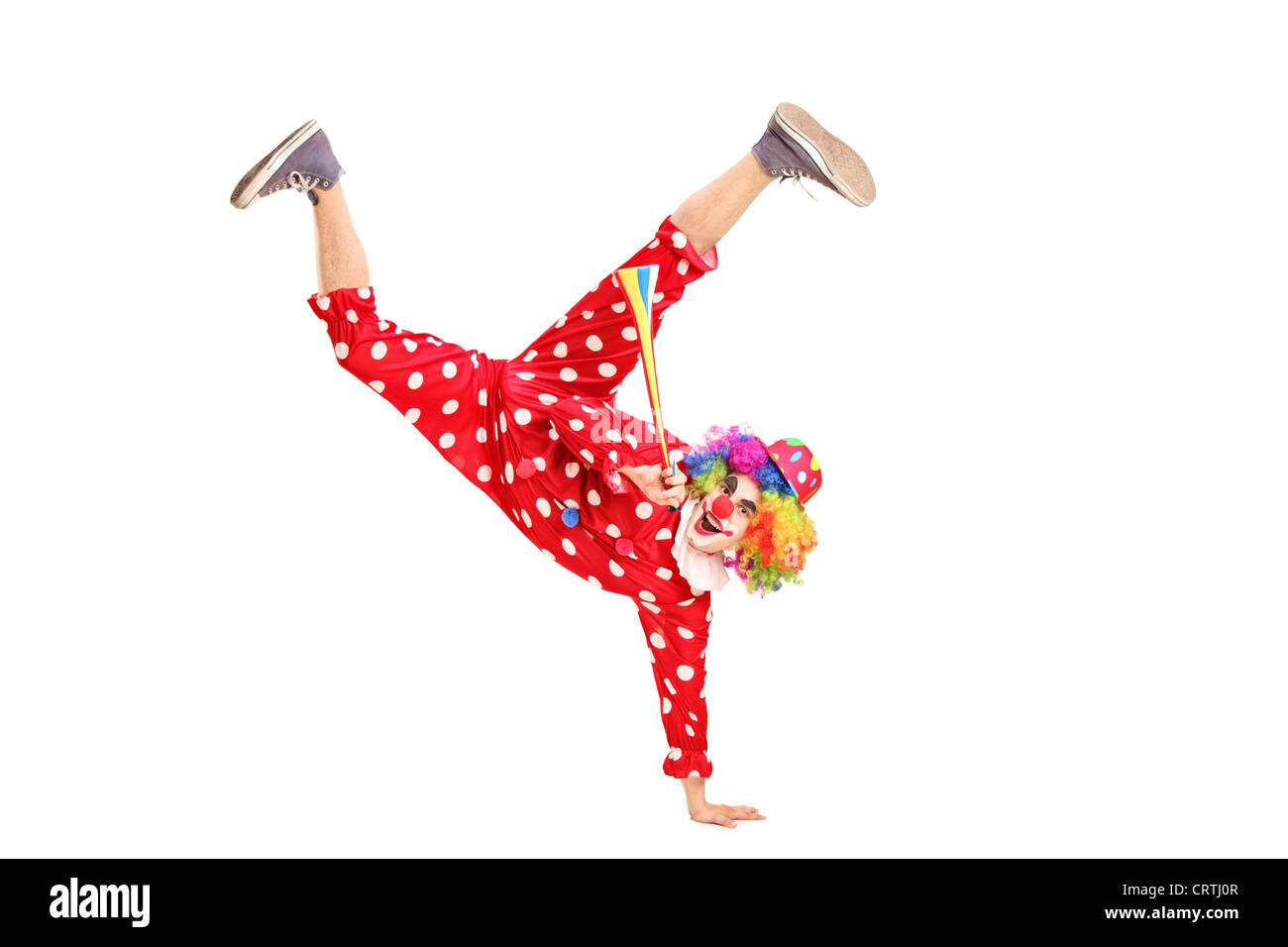 A playful clown with happy expression on face, holding a horn isolated ...