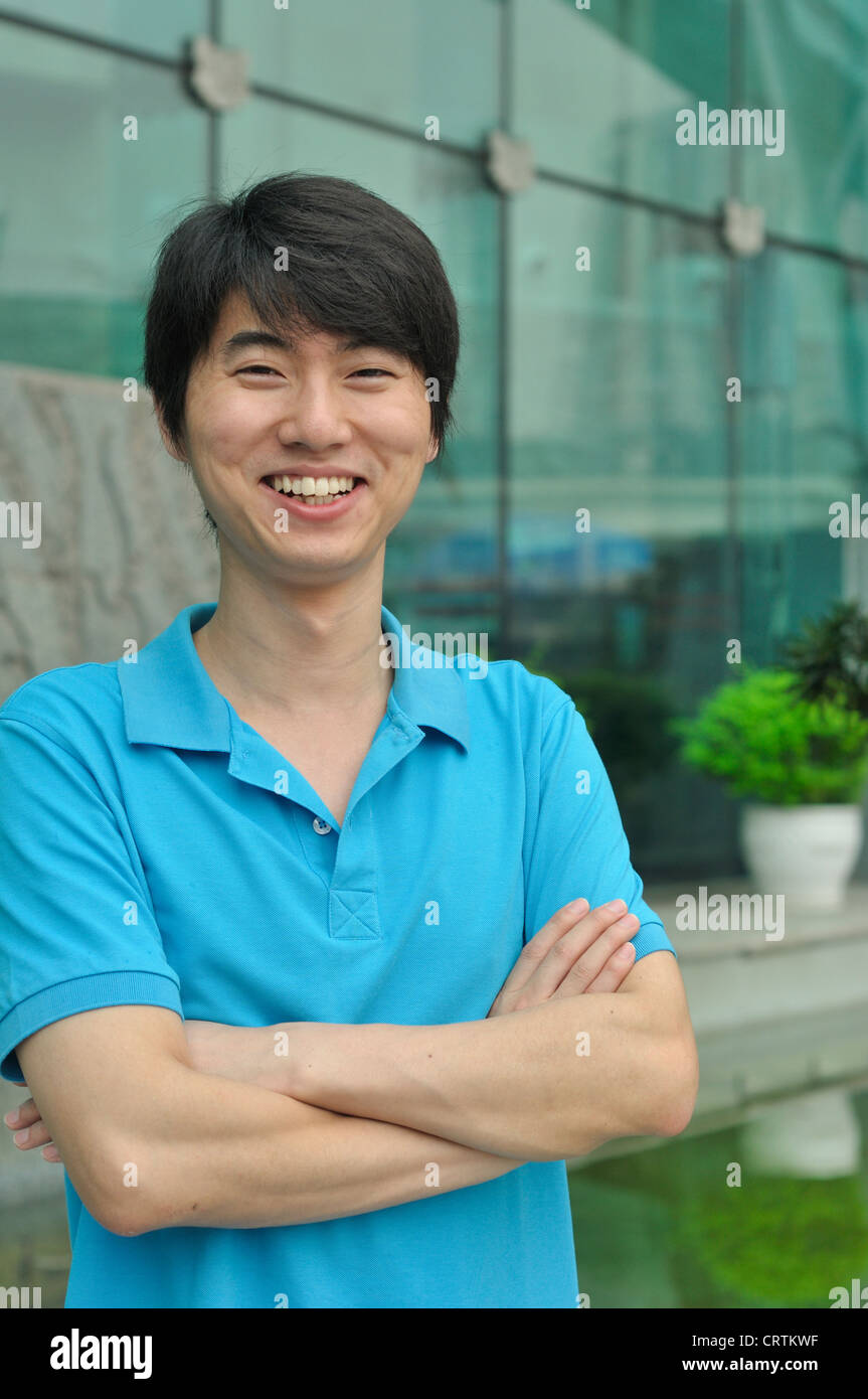 Cheerful young chinese man arms hi-res stock photography and images - Alamy