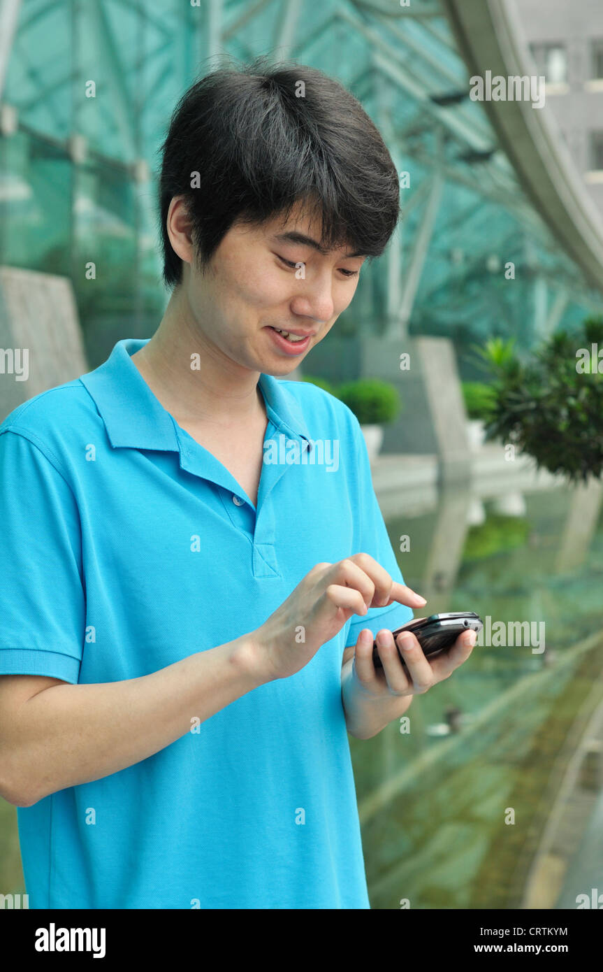 asian man texting Stock Photo - Alamy