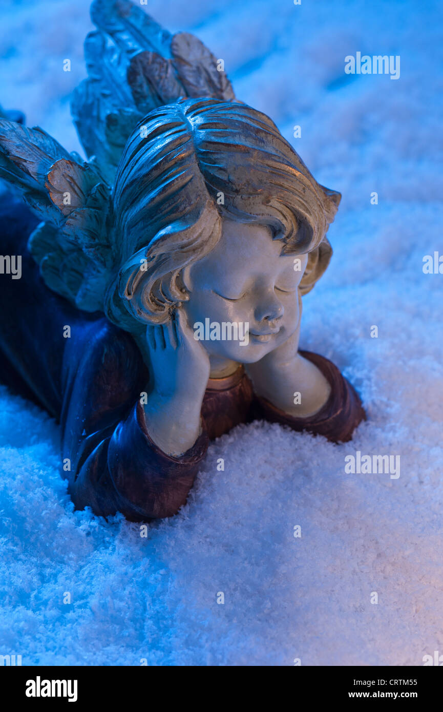 Angel in a beautiful blue snow setting Stock Photo - Alamy