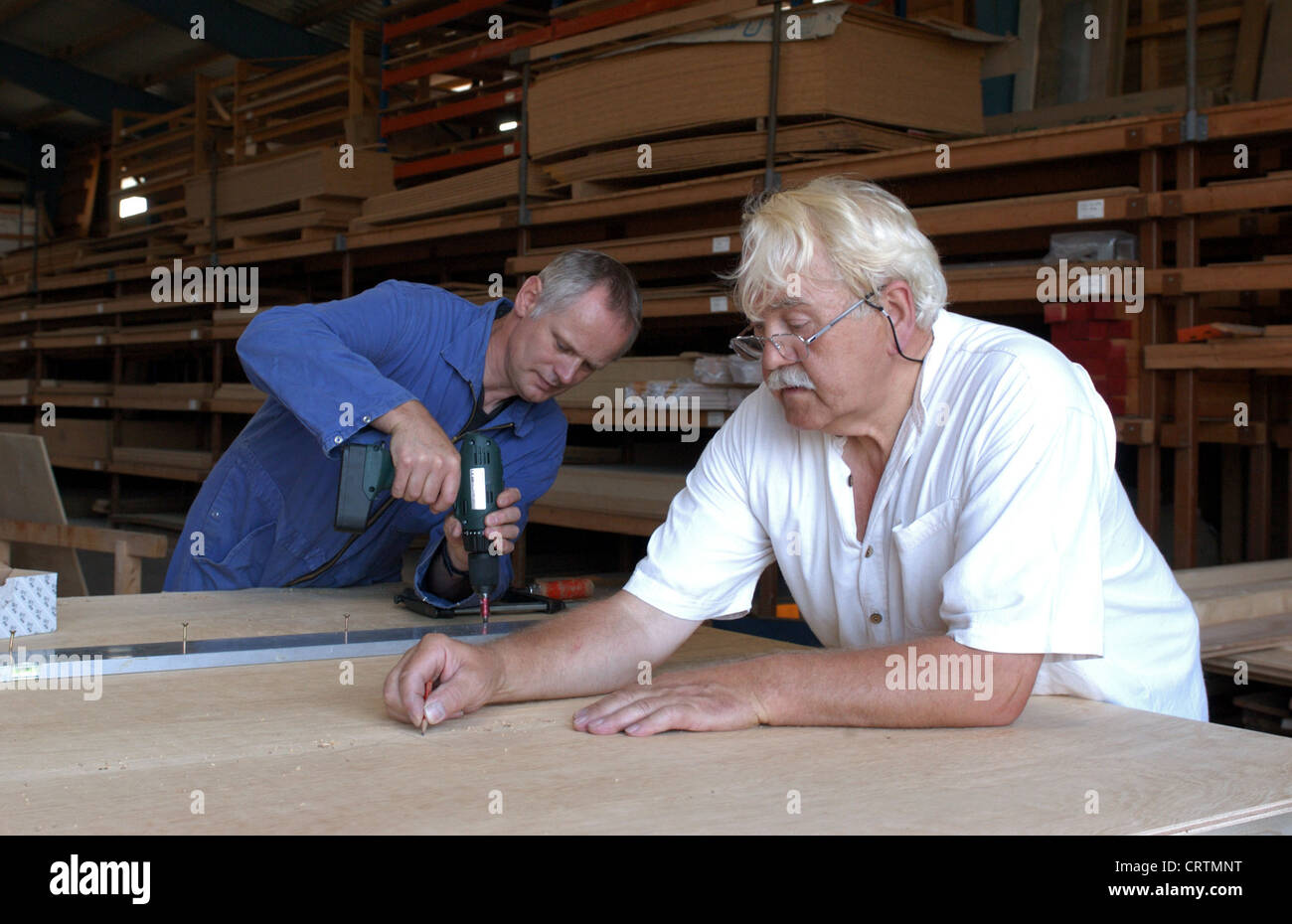 Carpenter and his staff during the assembly of market stalls Stock ...