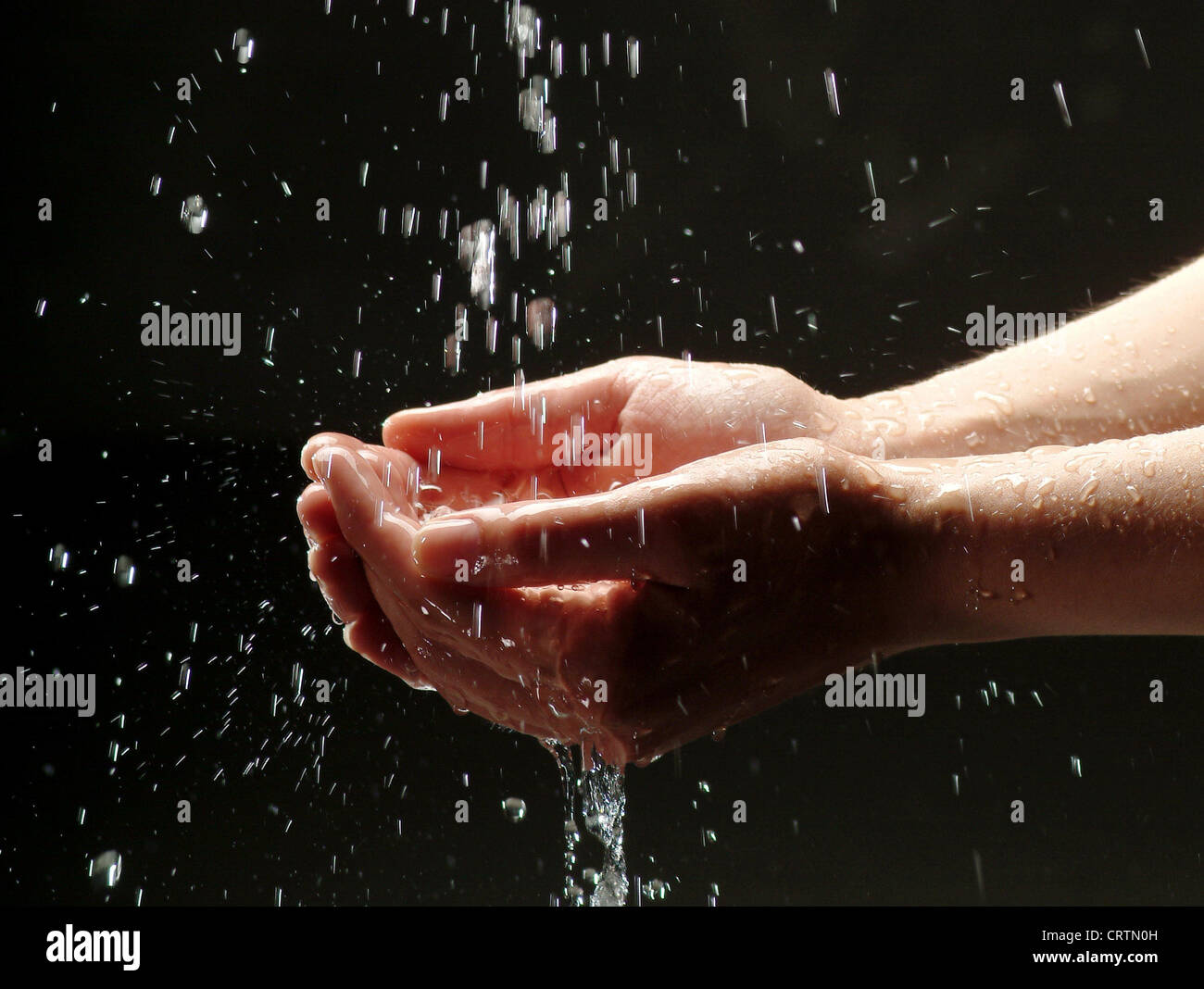 Hands under a stream of water Stock Photo - Alamy