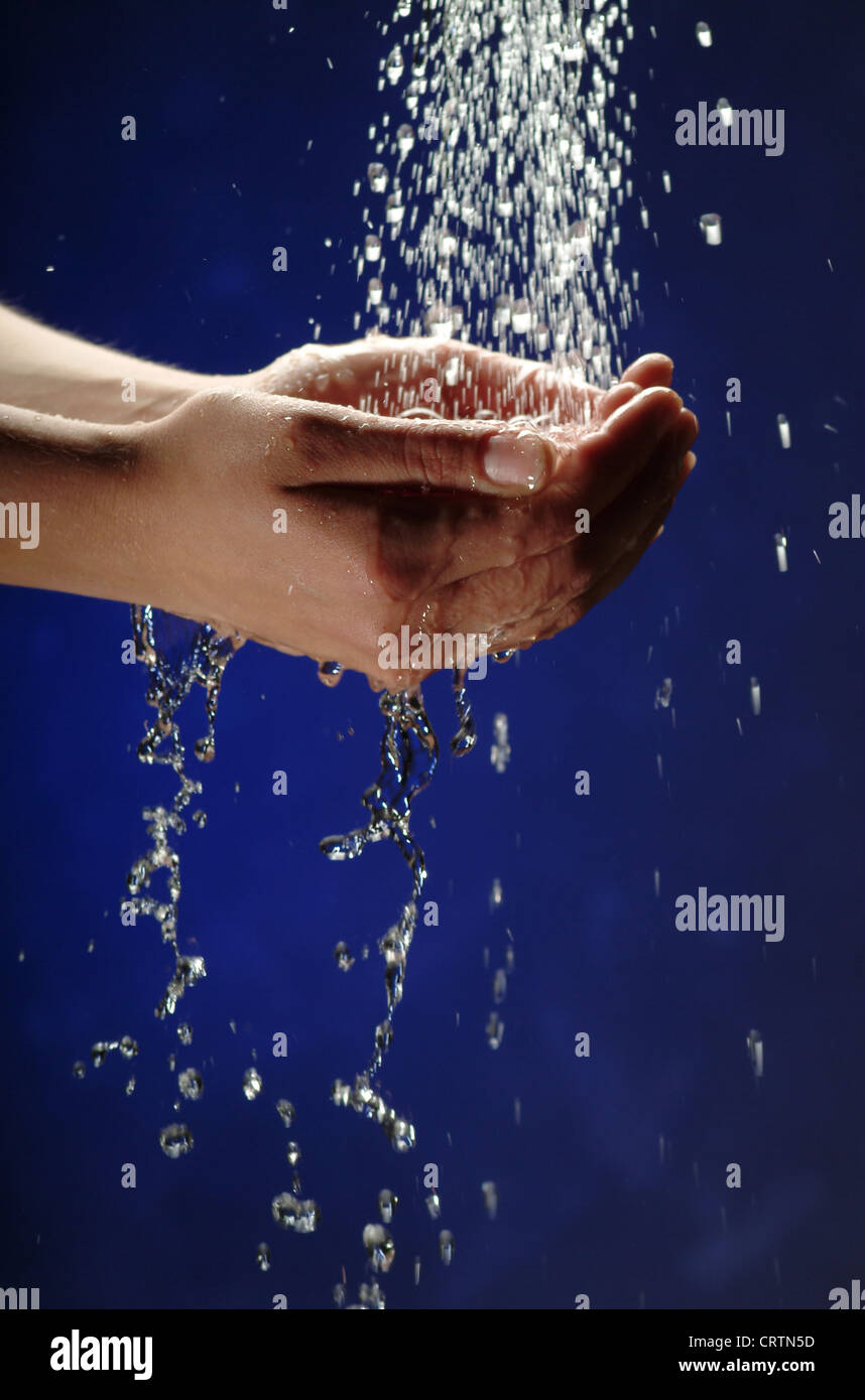 Hands under a stream of water Stock Photo - Alamy