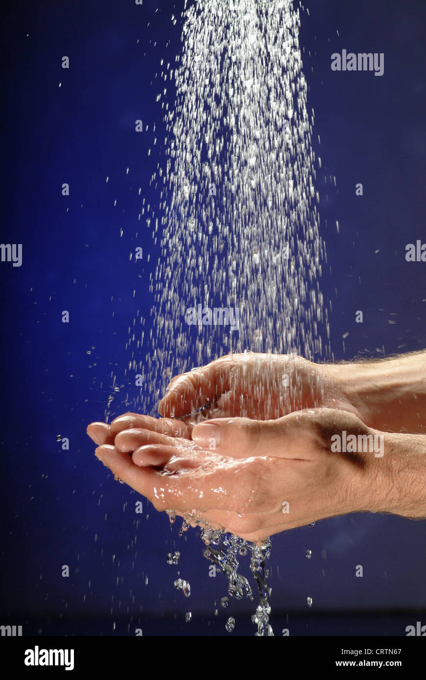 Hands under a stream of water Stock Photo - Alamy