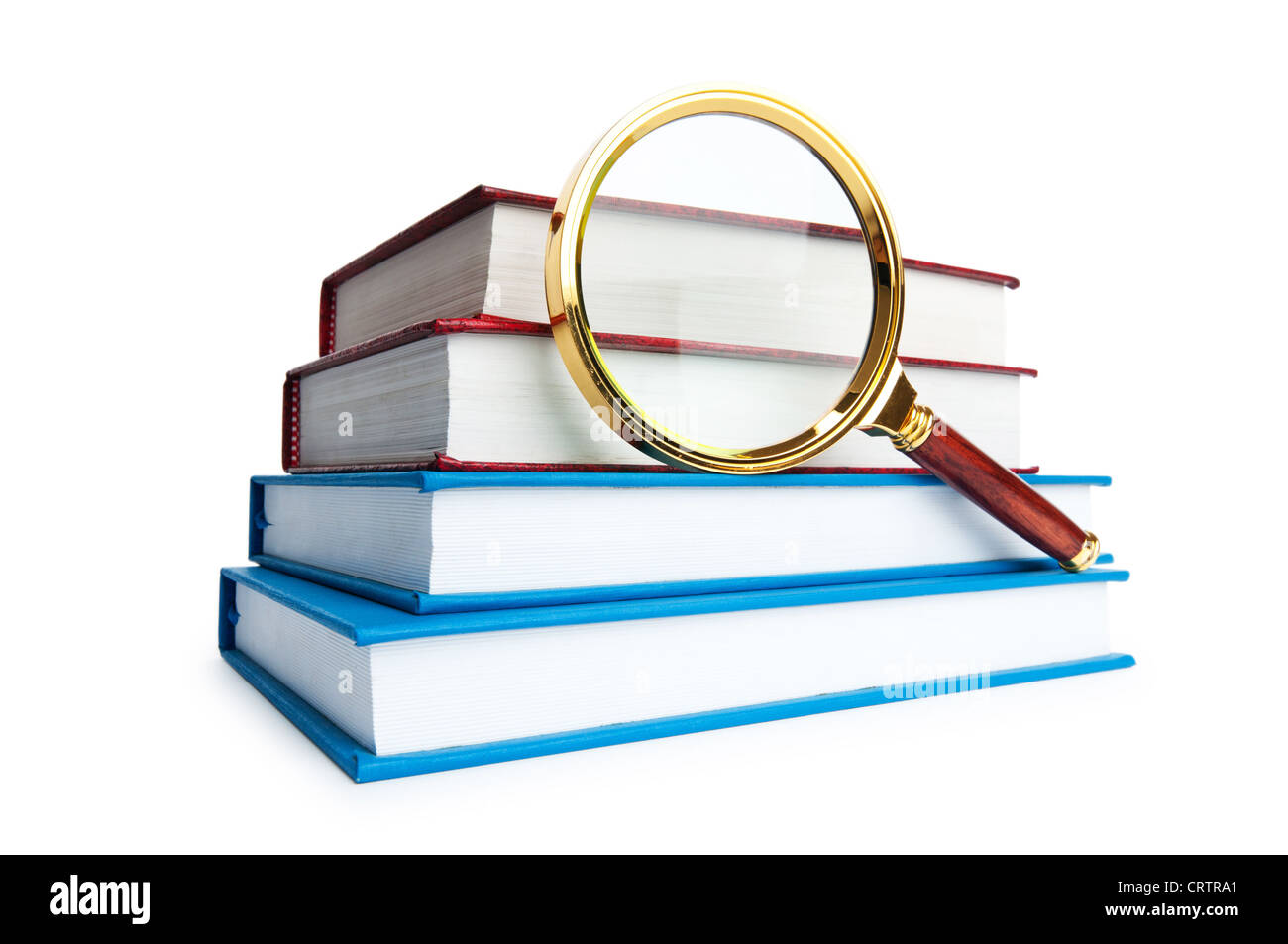 Magnifying glass over the stack of books Stock Photo - Alamy