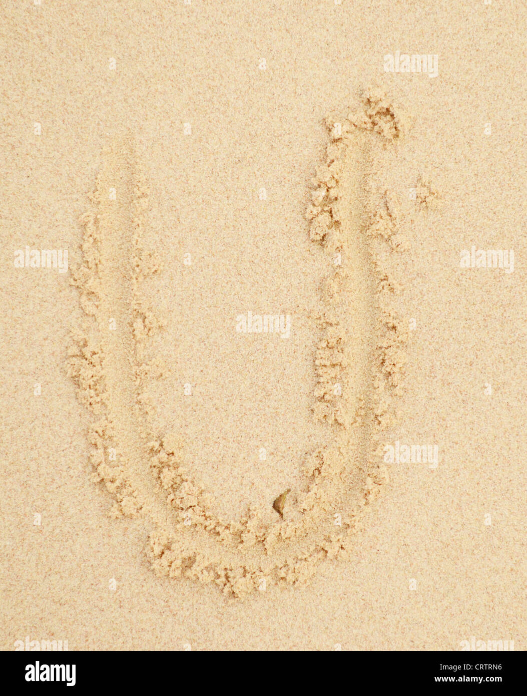 u letter written in the sand Stock Photo - Alamy