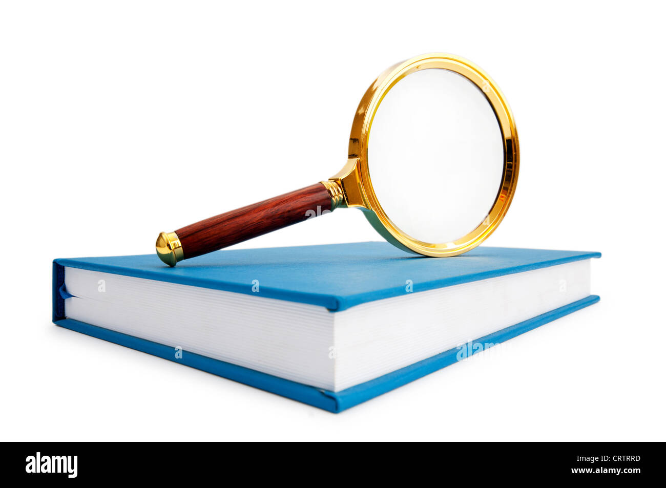 Magnifying glass over the stack of books Stock Photo - Alamy