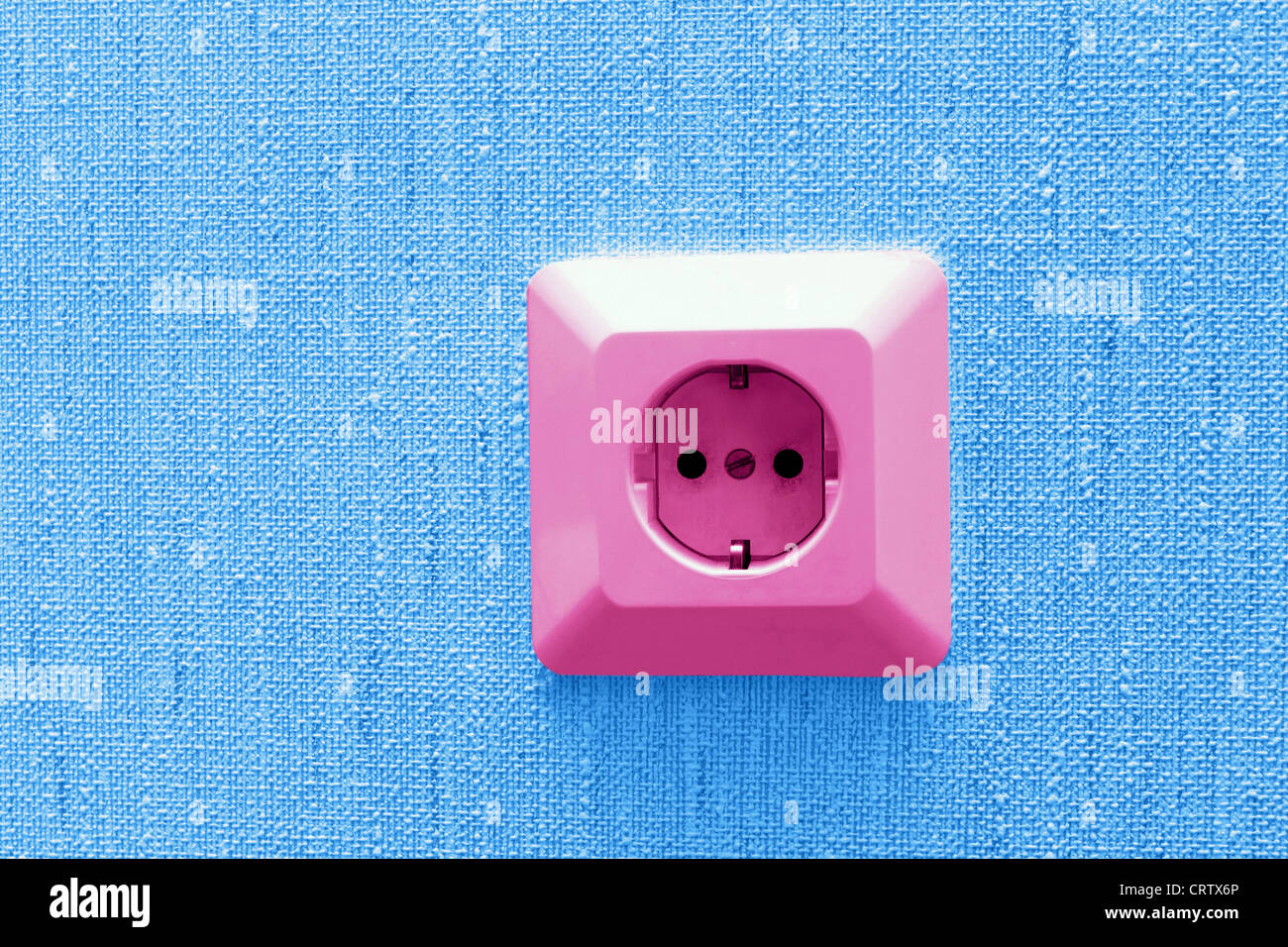 pink electric socket on blue wall Stock Photo - Alamy