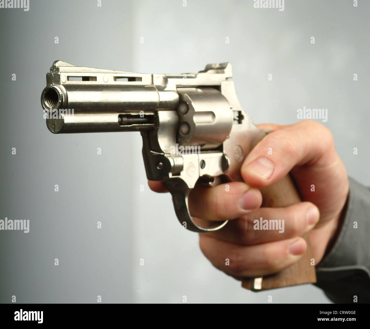 Hand with revolver Stock Photo - Alamy
