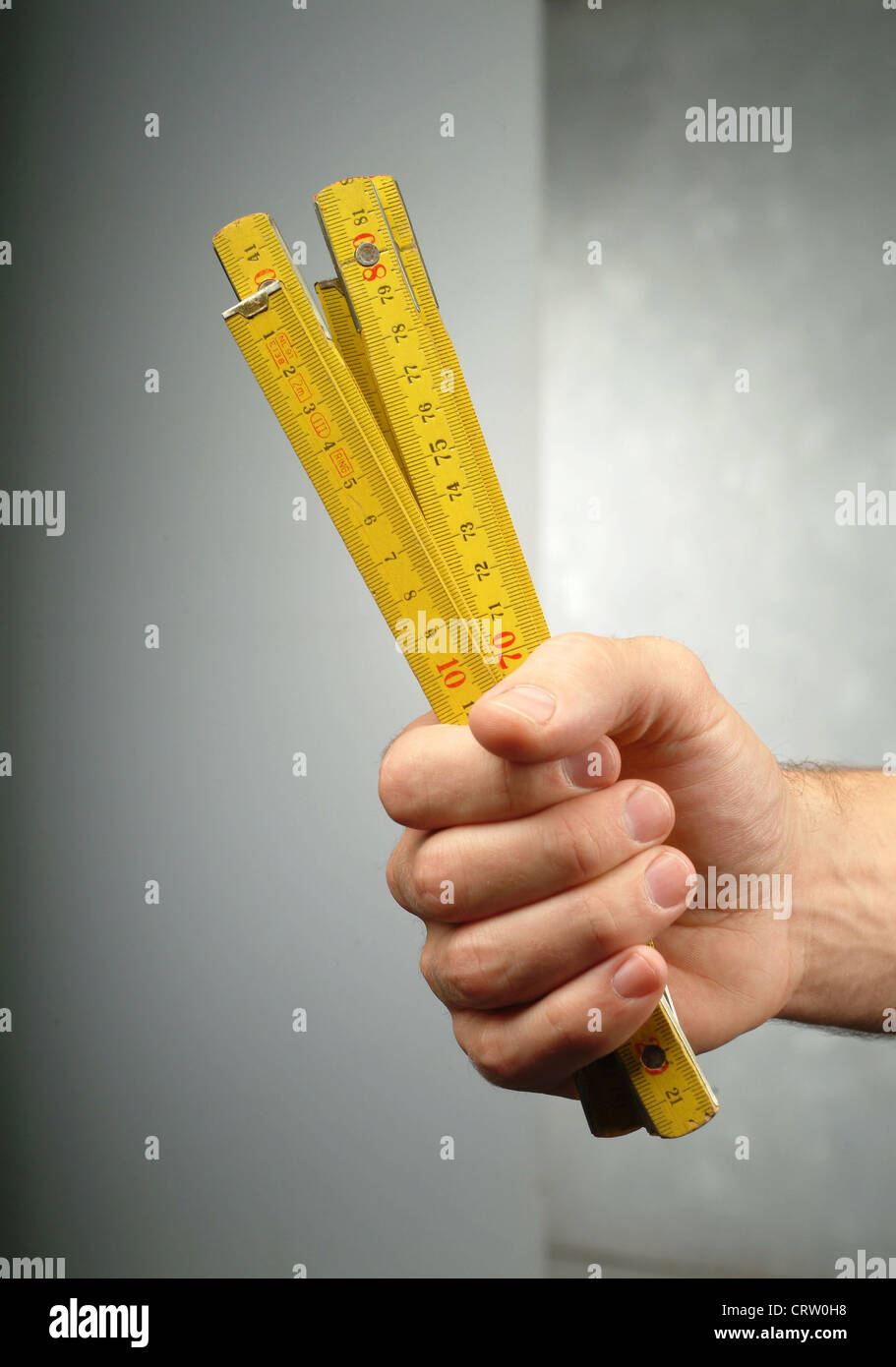 Hand with ruler Stock Photo - Alamy