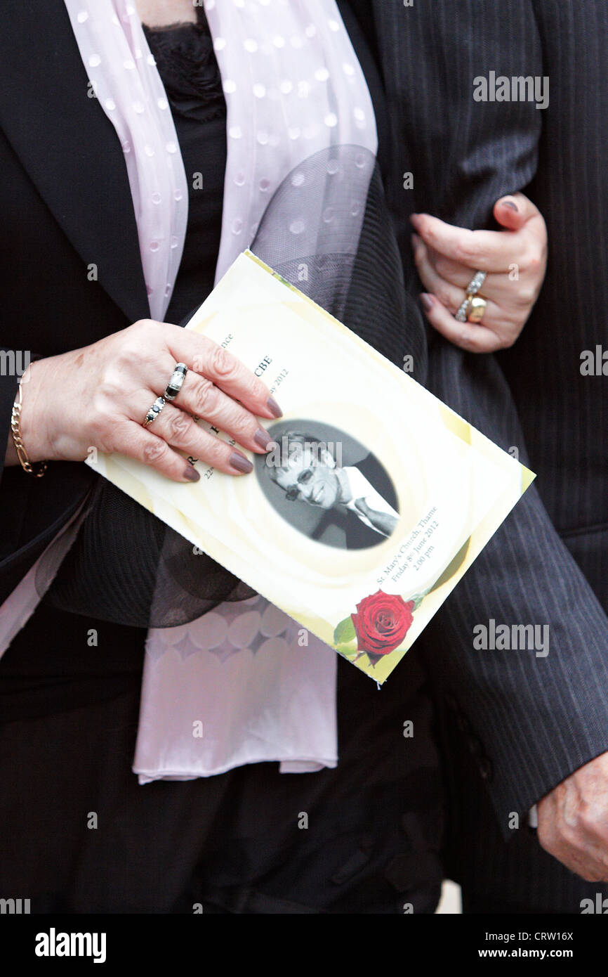 A woman carries an order of service from the funeral of Bee Gee singer ...