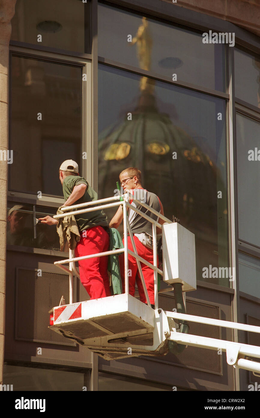 Window cleaners cleaning the glass facade of a house Stock Photo - Alamy