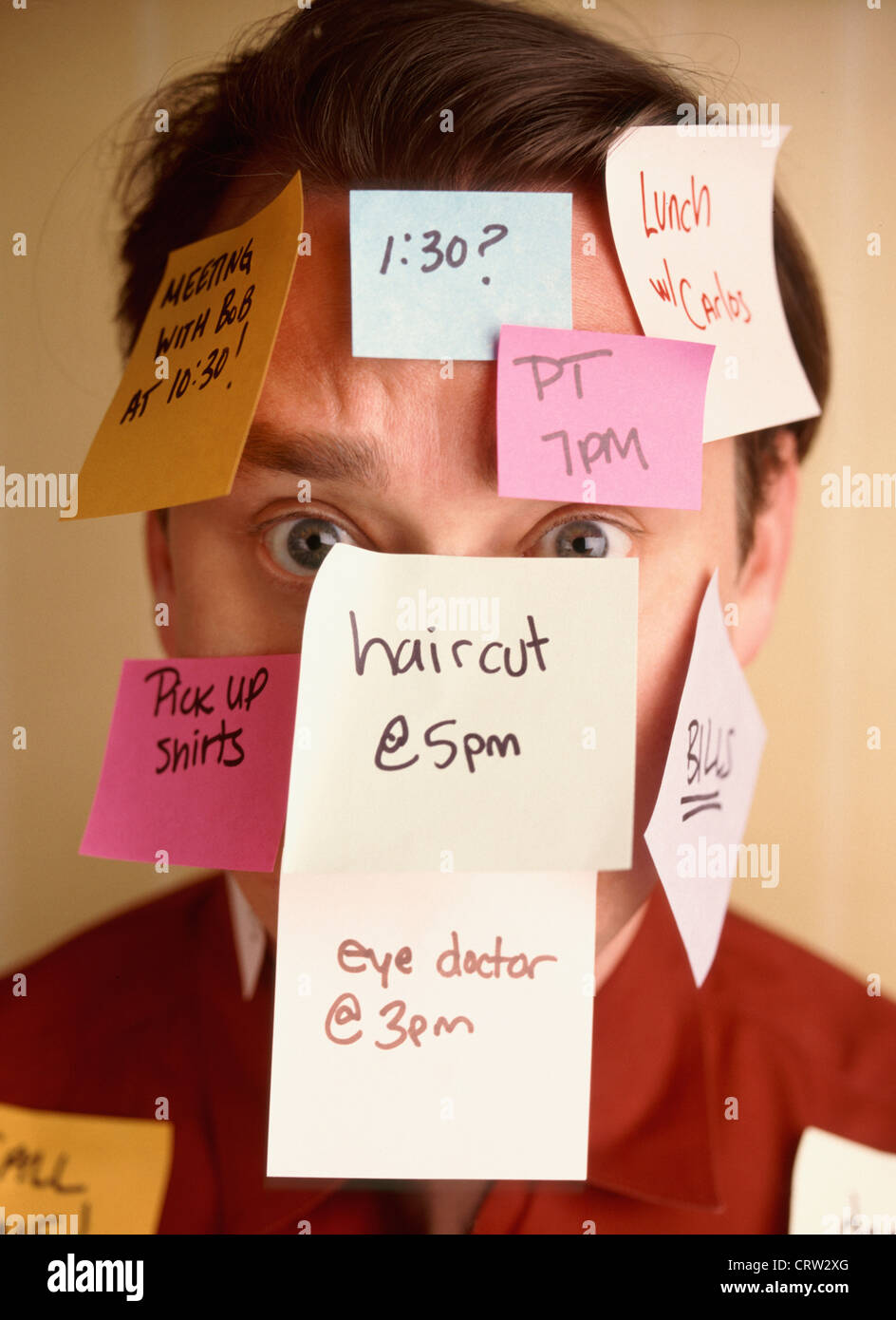 A busy man with post-it reminders on his face Stock Photo - Alamy