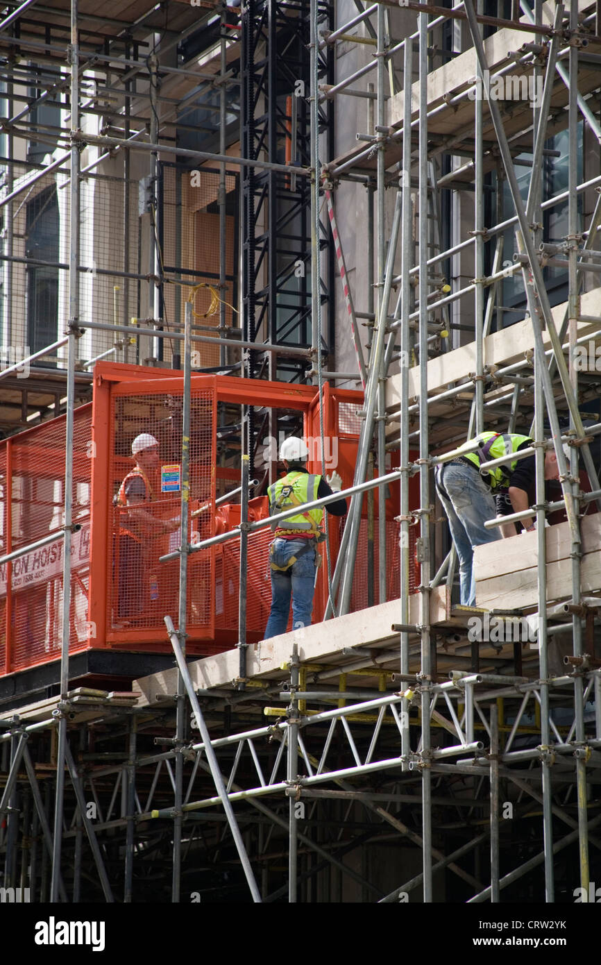 Construction workers on scaffolding in City of London Stock Photo - Alamy