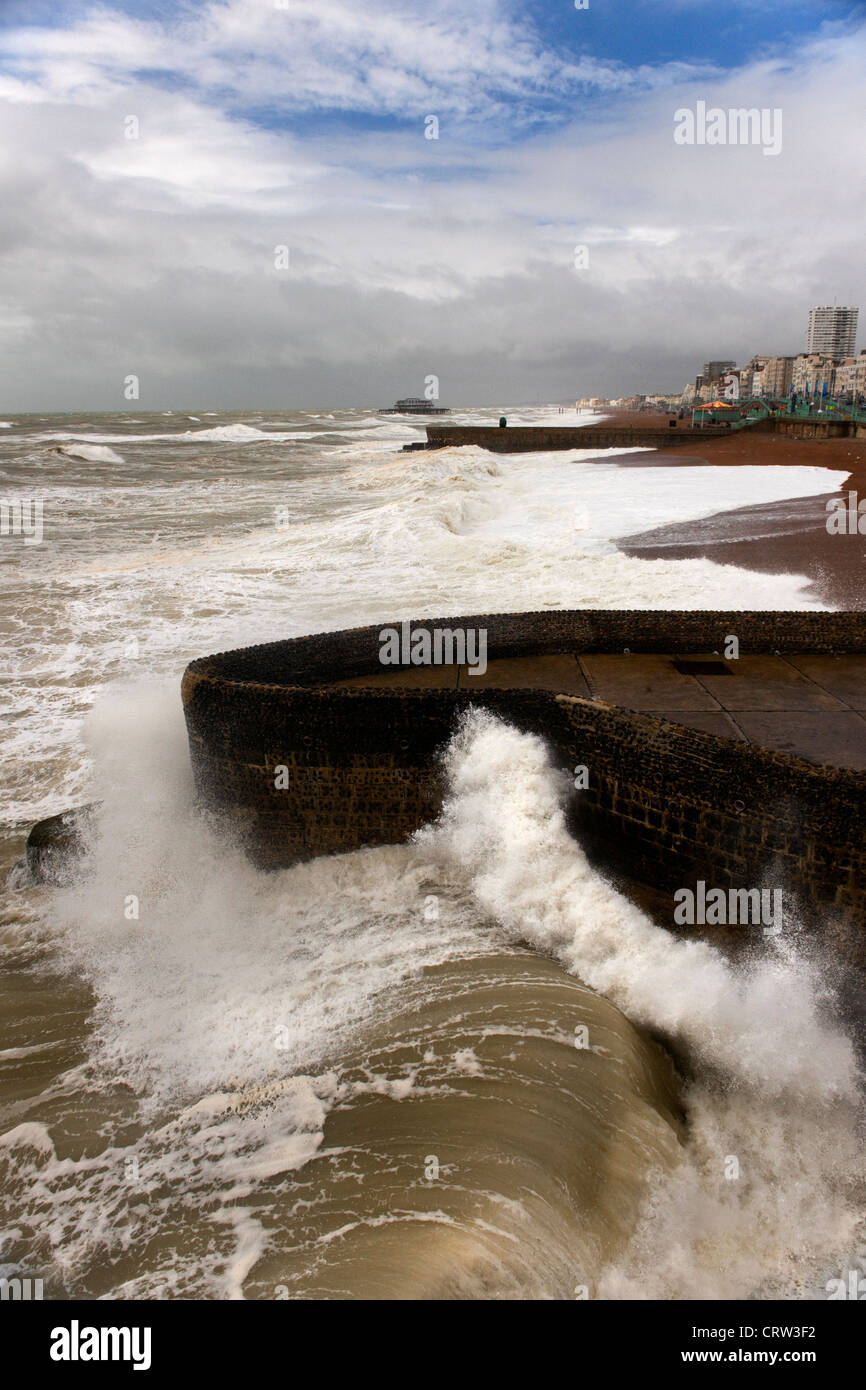 Brighton seafront on a windy day off season with waves washing over the ...