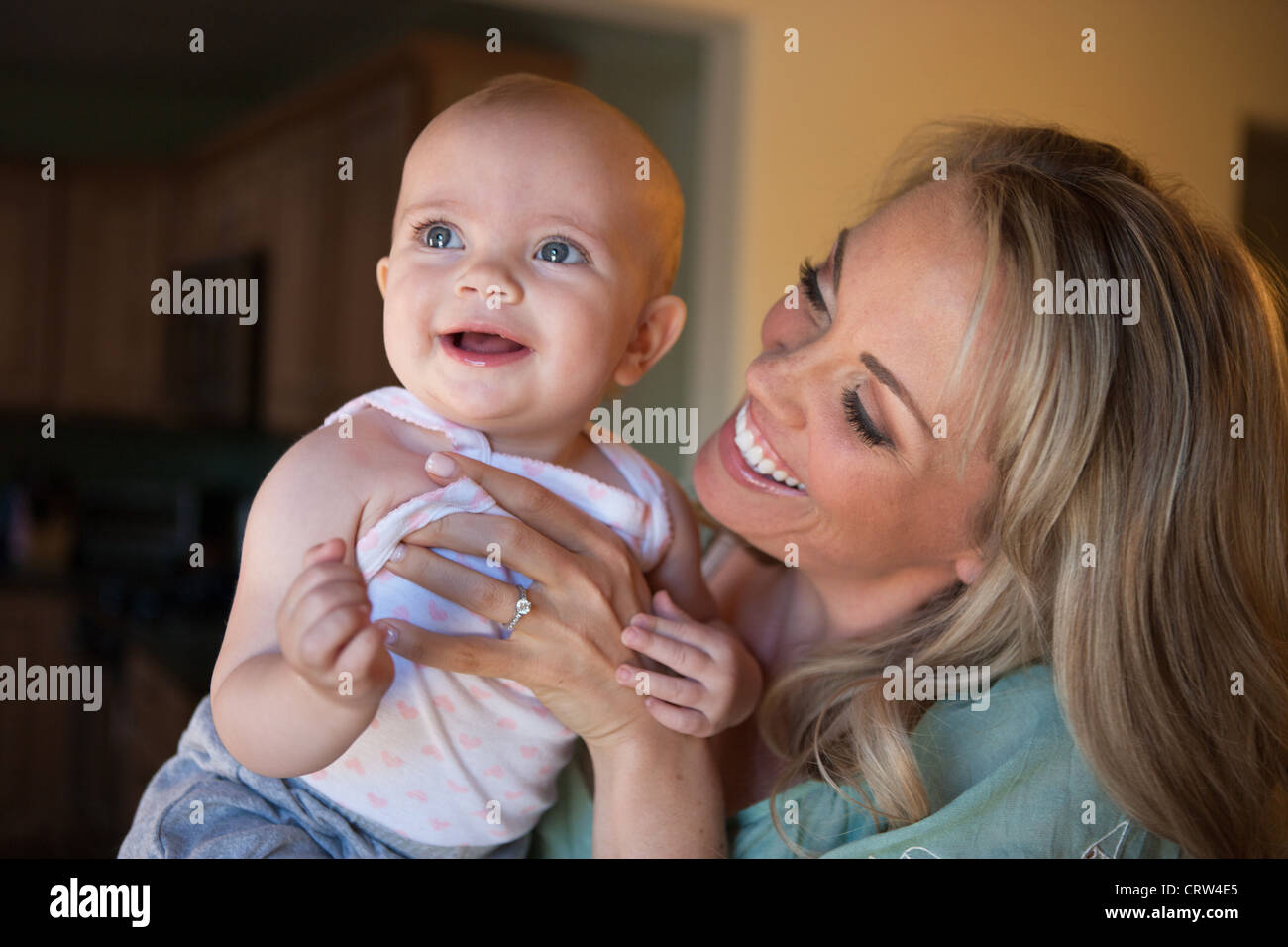 Happy mother smiling at her happy one year old at home Stock Photo - Alamy