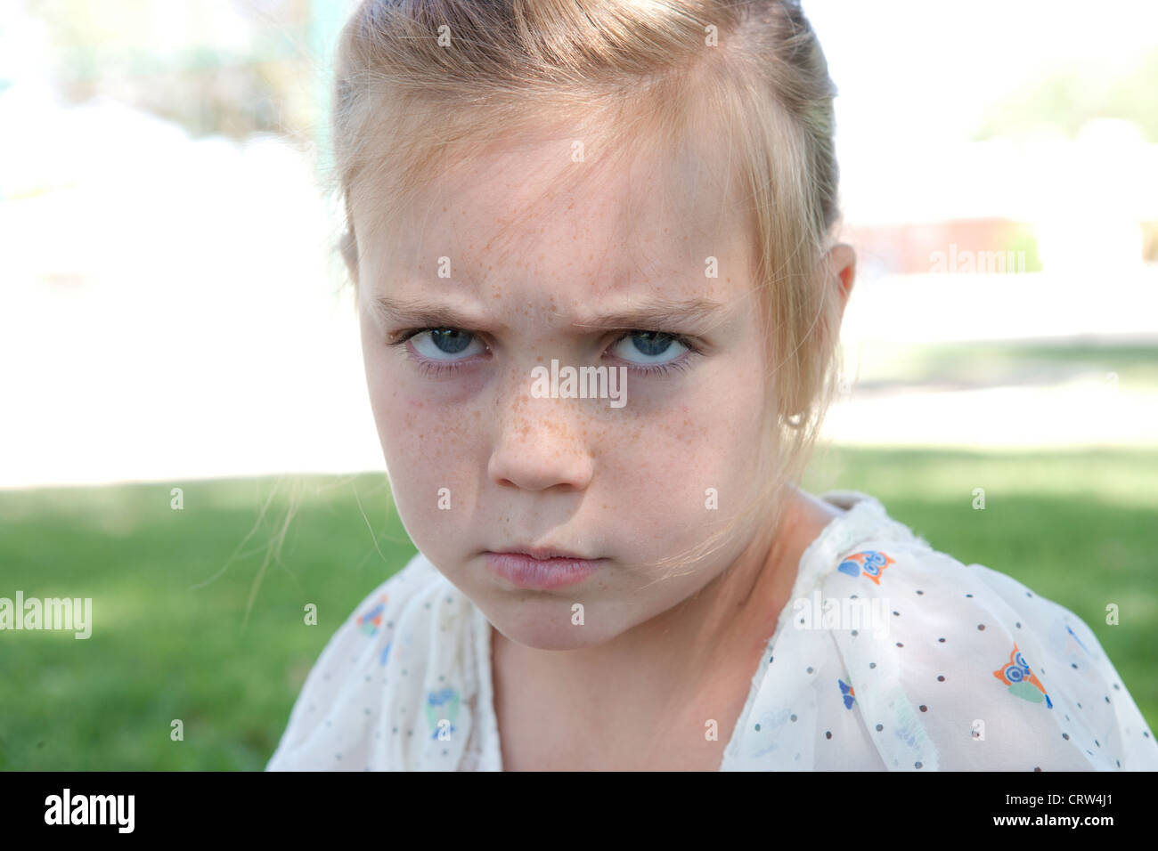 Angry ten year old girl looks at camera, outdoors Stock Photo - Alamy