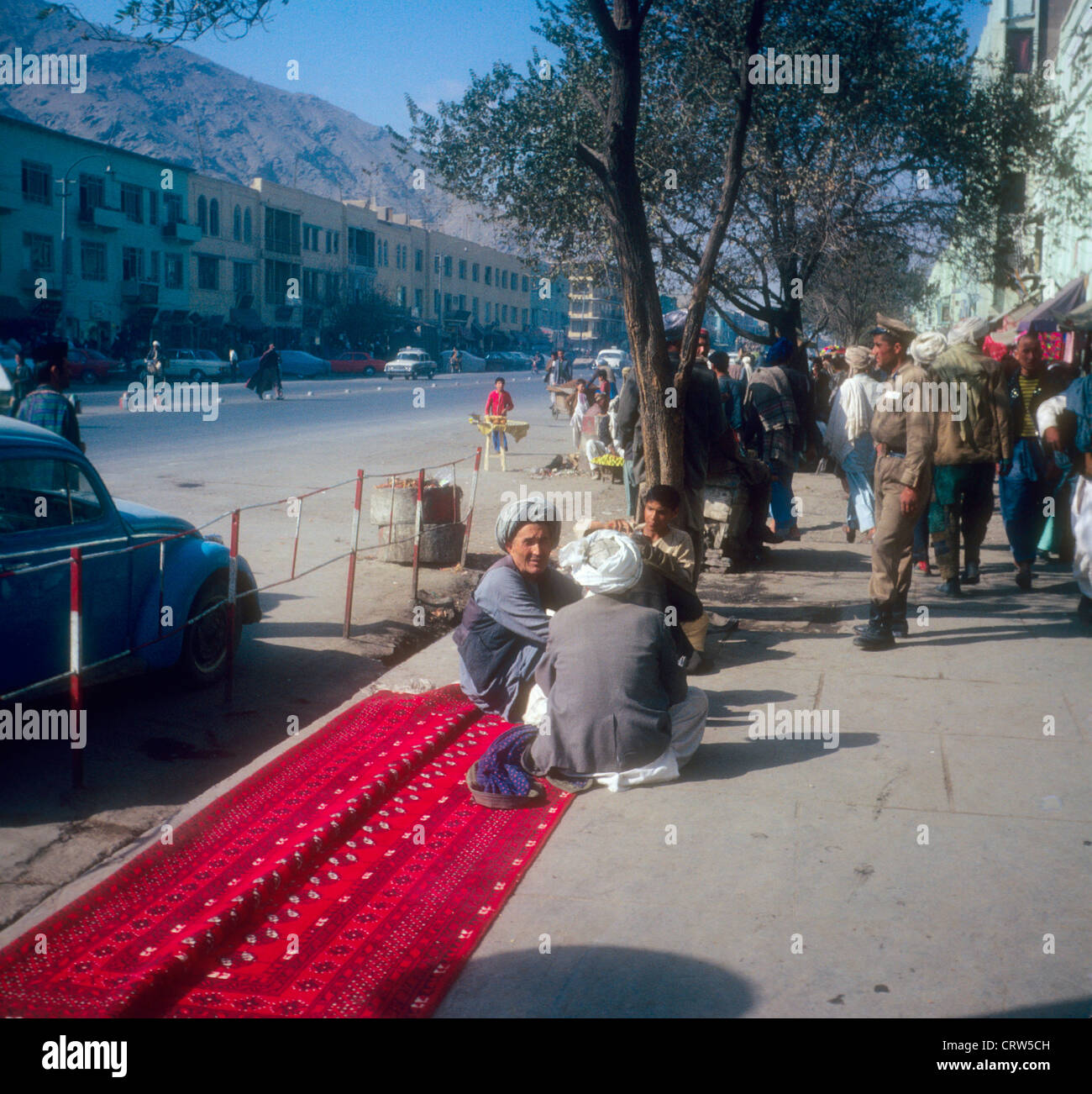 Men sitting on sidewalk next to rug in afghanistan before the Soviet ...