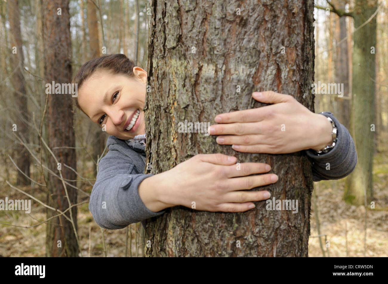 young woman hugging a tree Stock Photo - Alamy