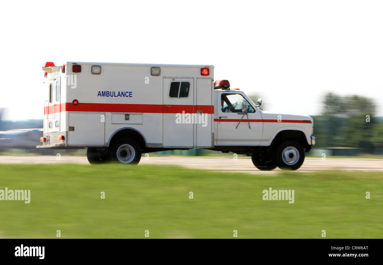 Ambulance driving fast Stock Photo - Alamy