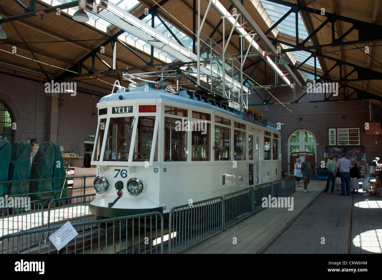 old dutch tram with people getting information about it in the open air ...