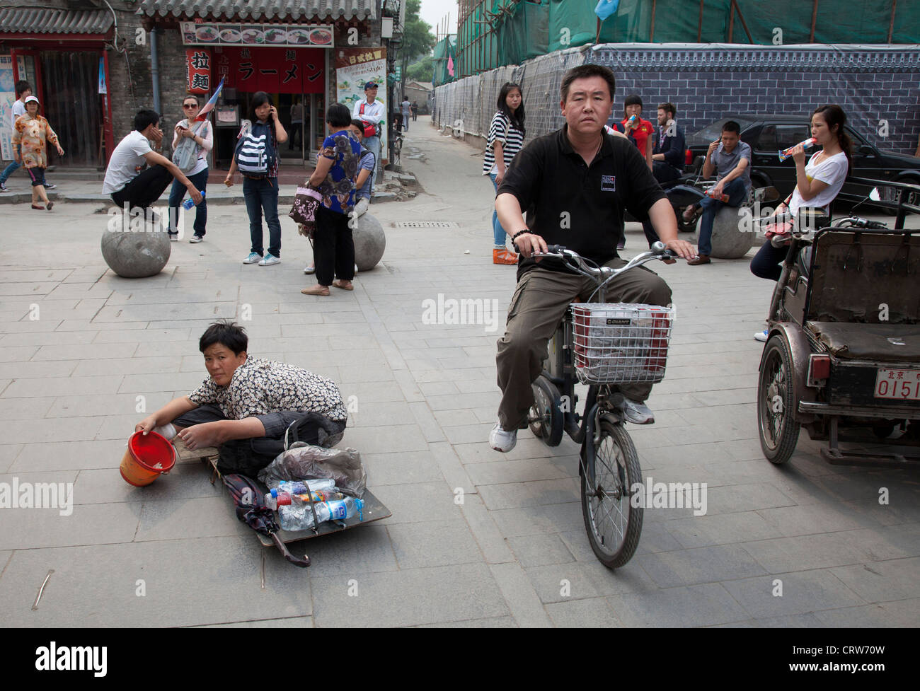 Beggar on Yandai Xiejie hutong Street in Beijing, China. Begging people ...