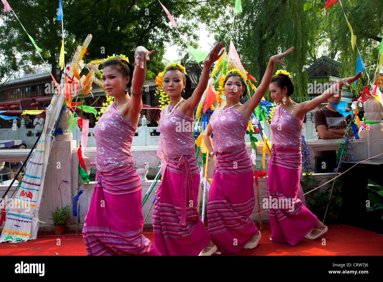 Traditional dancers dressed in beautiful costumes perform a dance on a ...