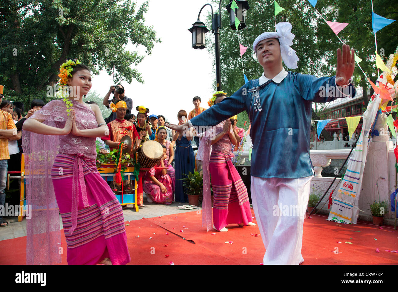 Traditional dancers dressed in beautiful costumes perform a dance on a ...