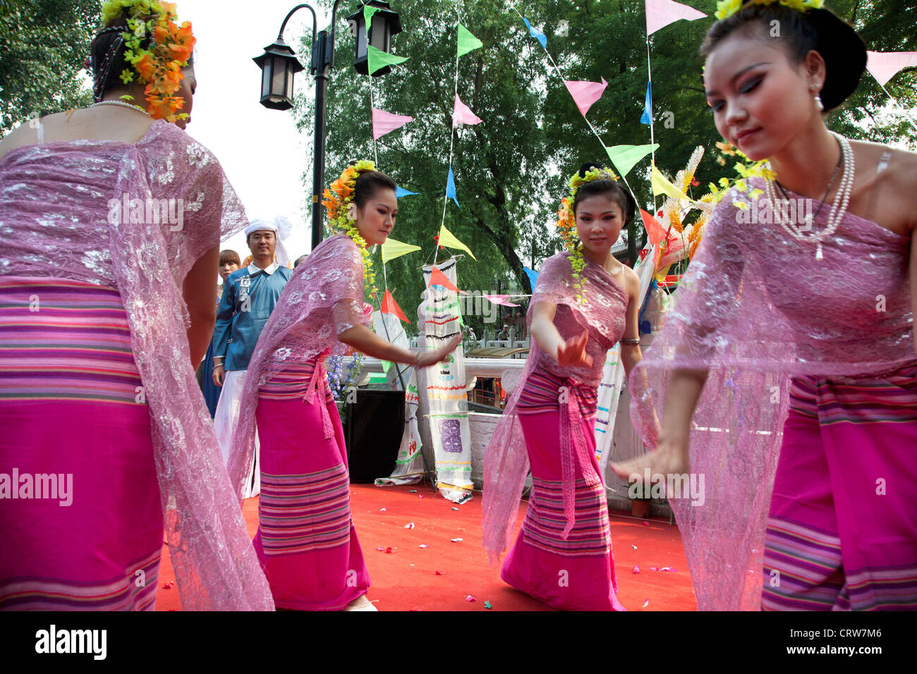 Traditional dancers dressed in beautiful costumes perform a dance on a ...