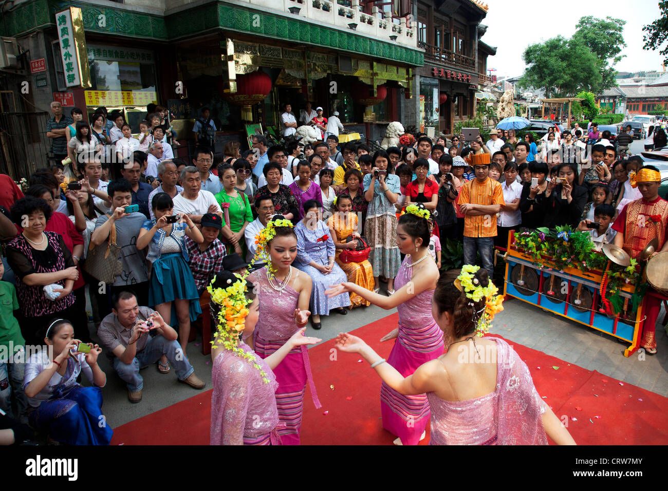 Traditional dancers dressed in beautiful costumes perform a dance on a ...