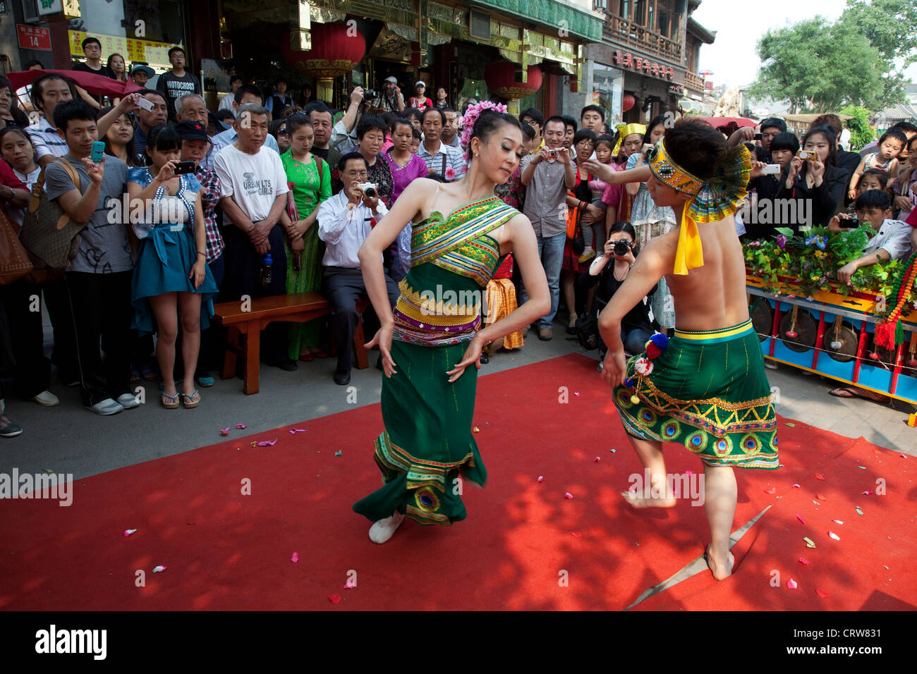 Traditional dancers dressed in beautiful costumes perform a dance on a ...