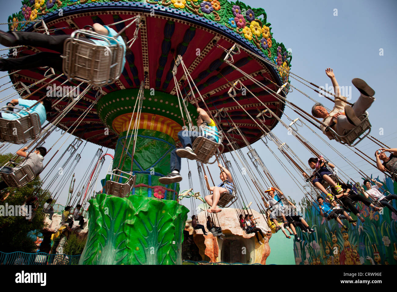 People enjoying a fair ground ride, a carousel which lifts them up on ...