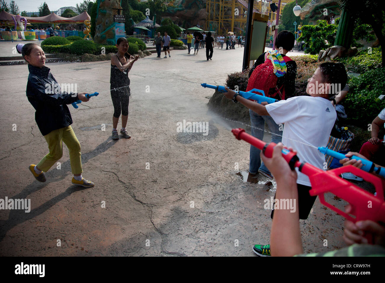 Children having a fun water fight with water pistols and guns. Happy ...