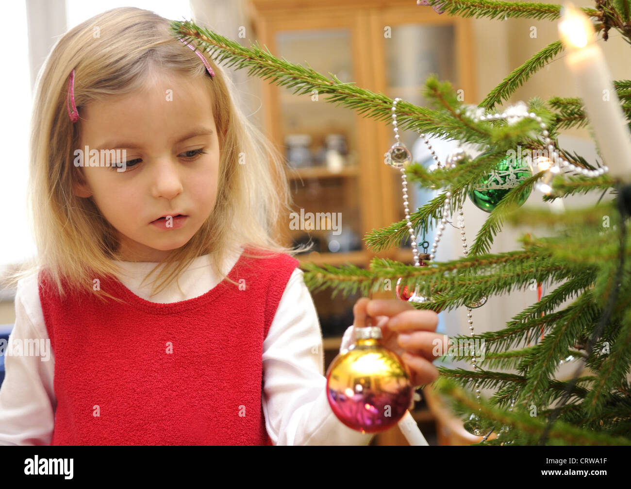 little girl decorating christmas tree Stock Photo - Alamy
