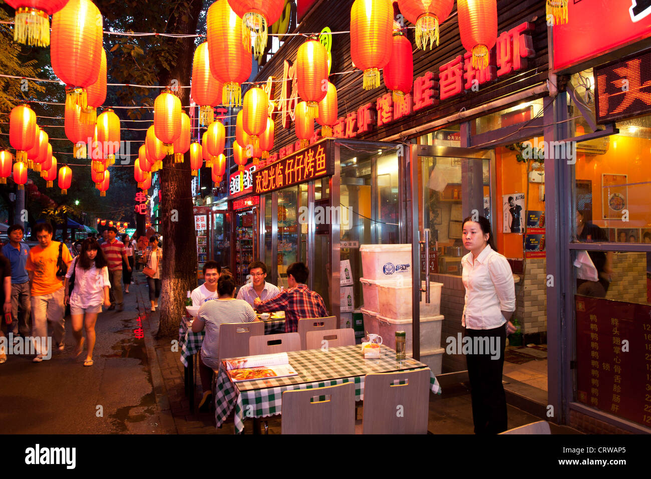 Customers outside as red lanterns hang overhead along Guijie food ...
