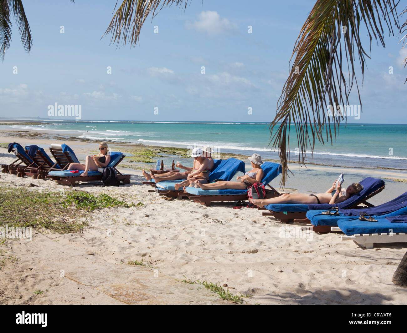 Tourists sunbathe at holiday resort on the beach at Tiwi, on Indian ...