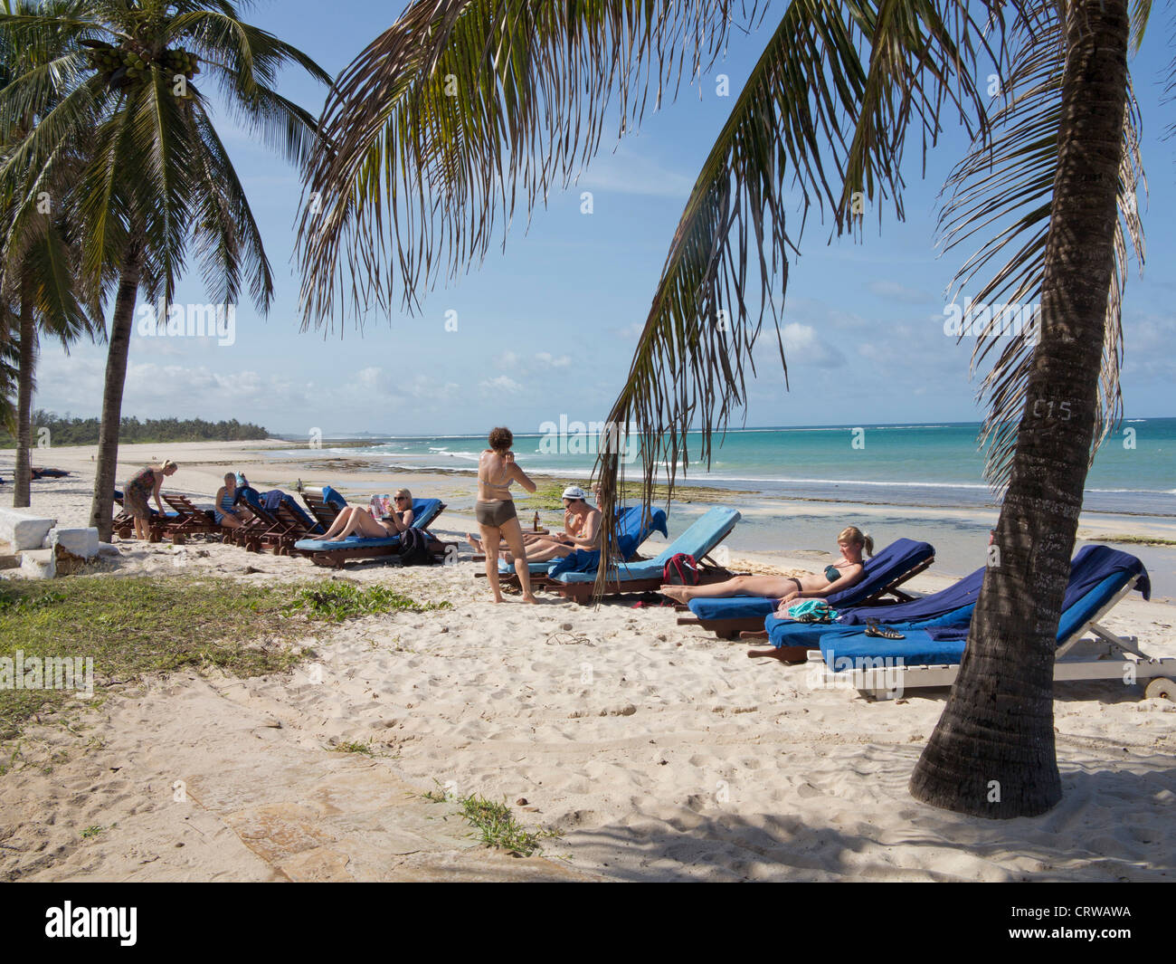 Tourists sunbathe at holiday resort on the beach at Tiwi, on Indian ...
