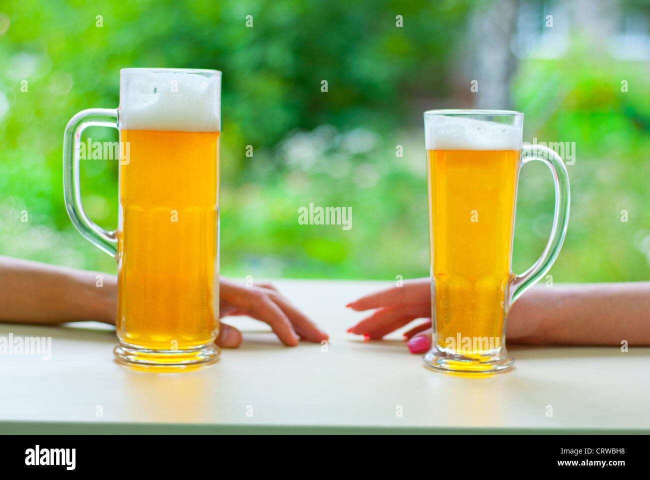 two human hands, man and woman with beer in glass Stock Photo - Alamy